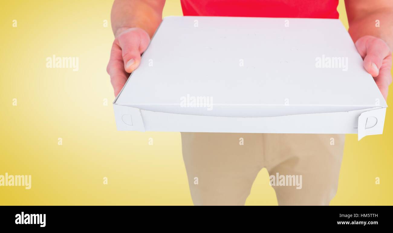 Delivery man carrying boxes against concrete wall Stock Photo - Alamy