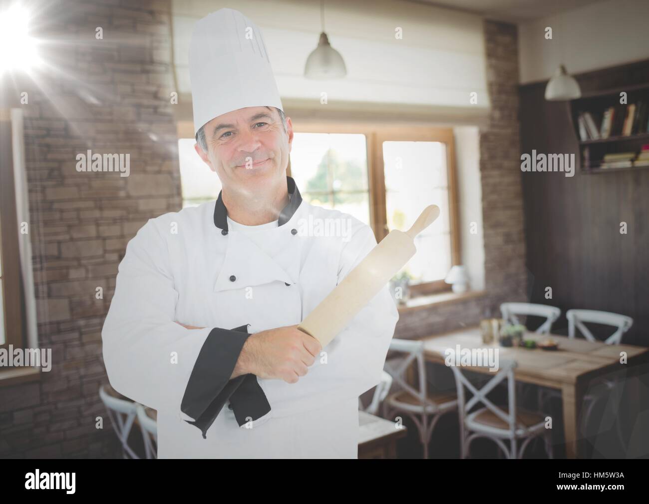 Male chef holding rolling pin in restaurant Stock Photo - Alamy