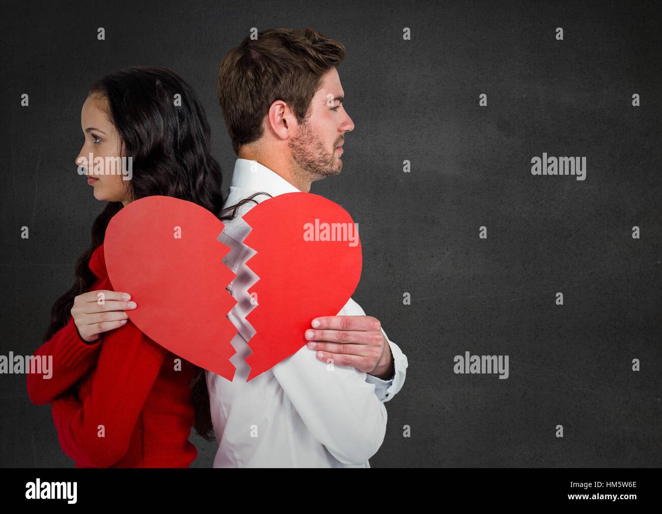 Depressed couple holding broken heart Stock Photo - Alamy