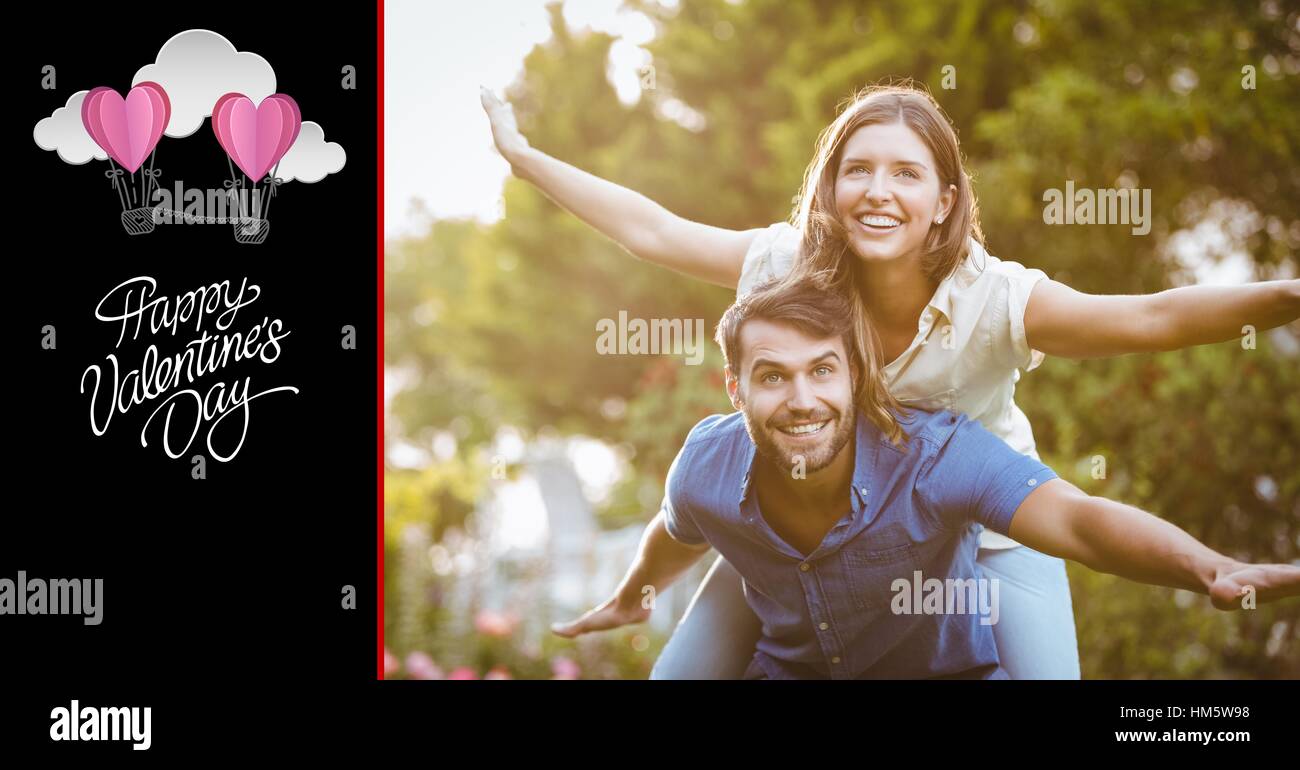 Couple pretending to fly in park Stock Photo - Alamy