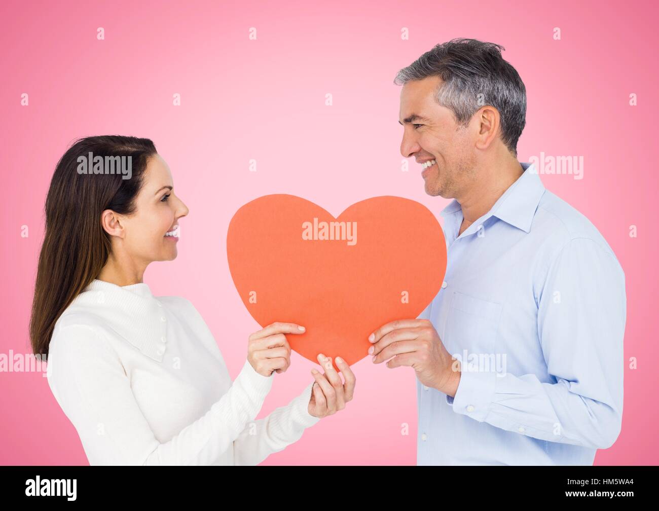 Romantic couple holding heart shape Stock Photo - Alamy