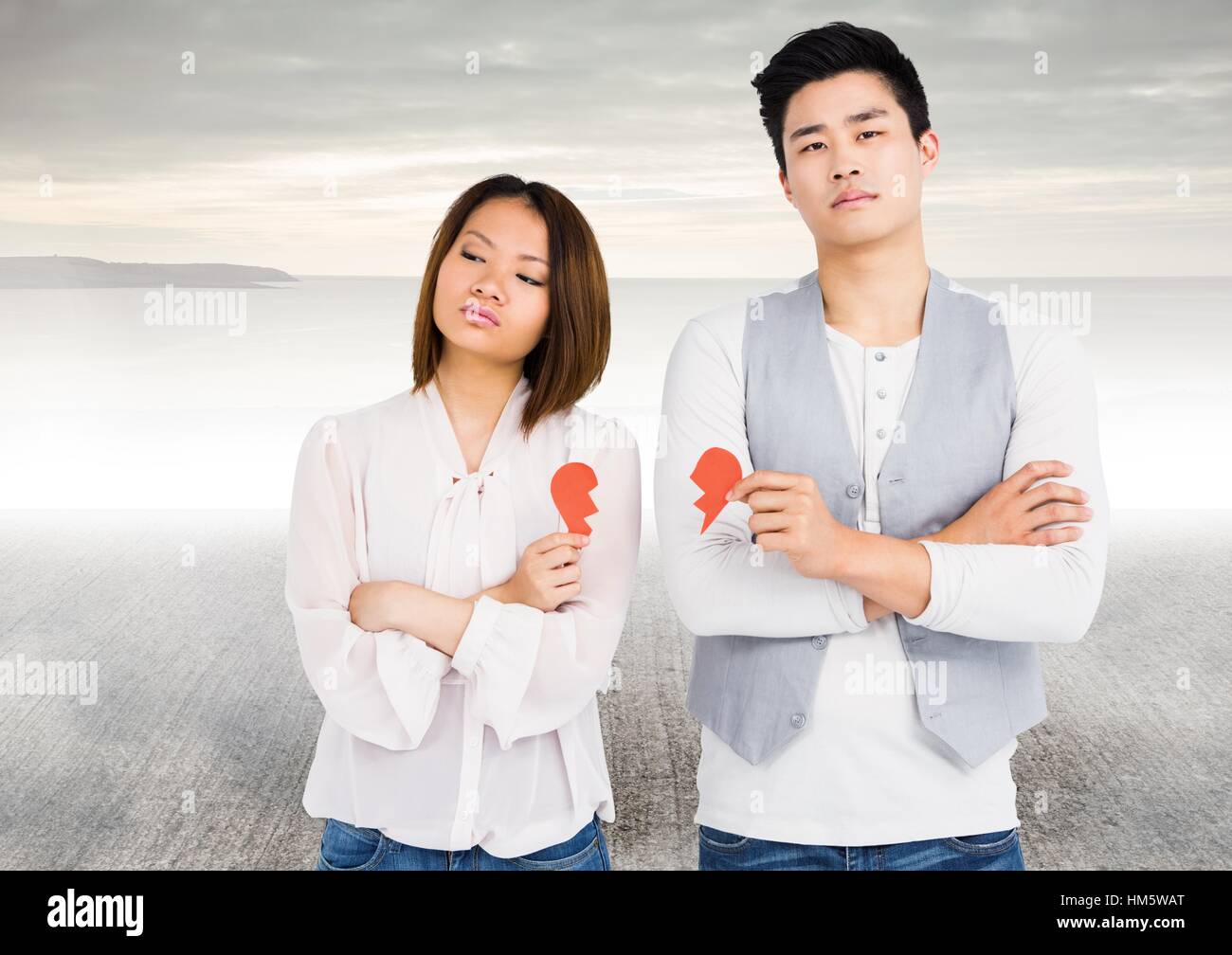 Depressed couple holding broken heart Stock Photo - Alamy