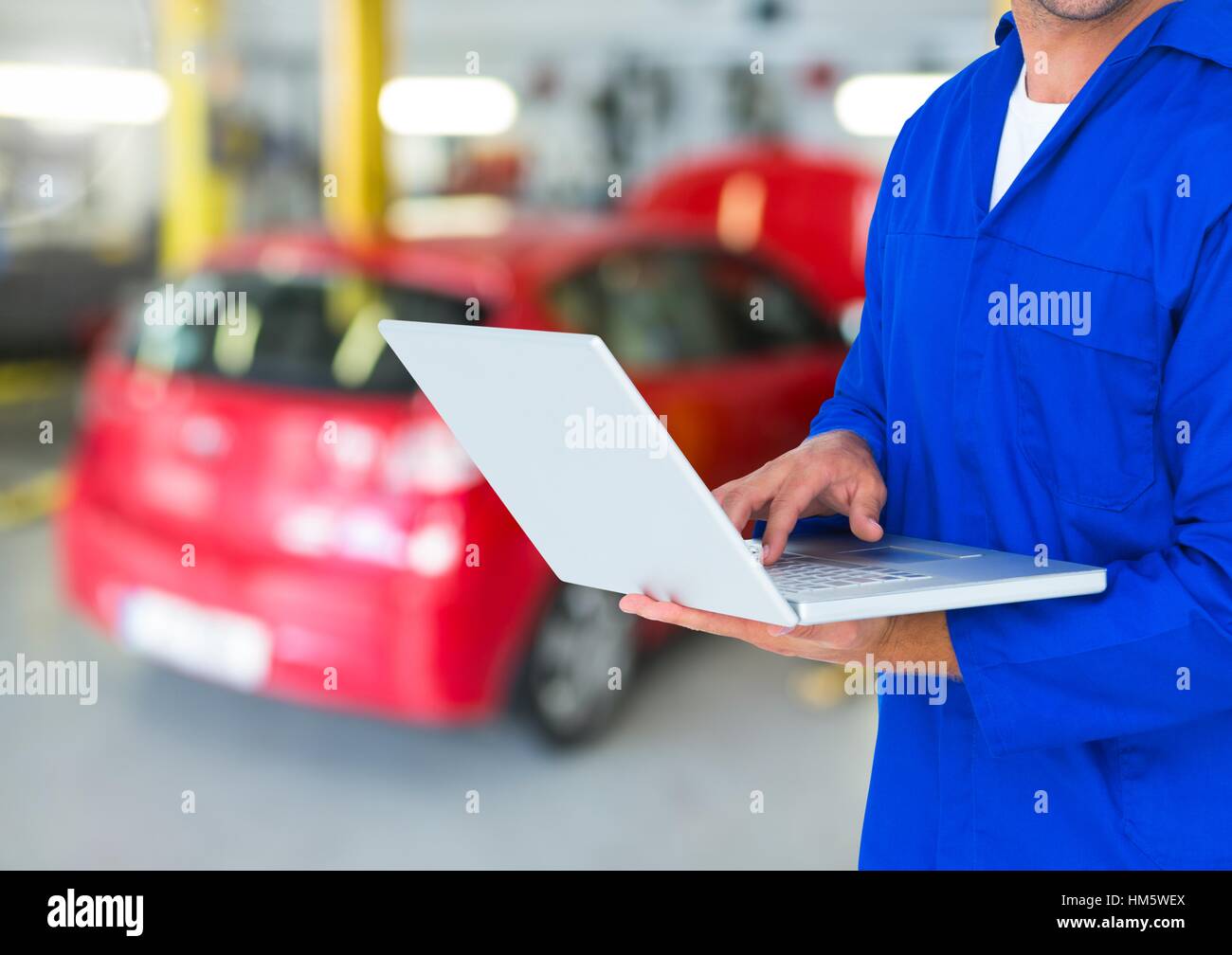 Car mechanic using laptop in repair garage Stock Photo - Alamy