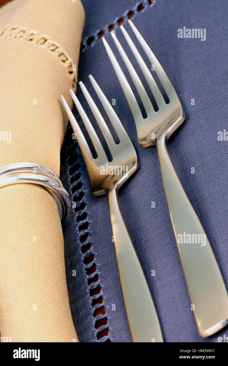 set of fine silverware on colorful table Stock Photo - Alamy