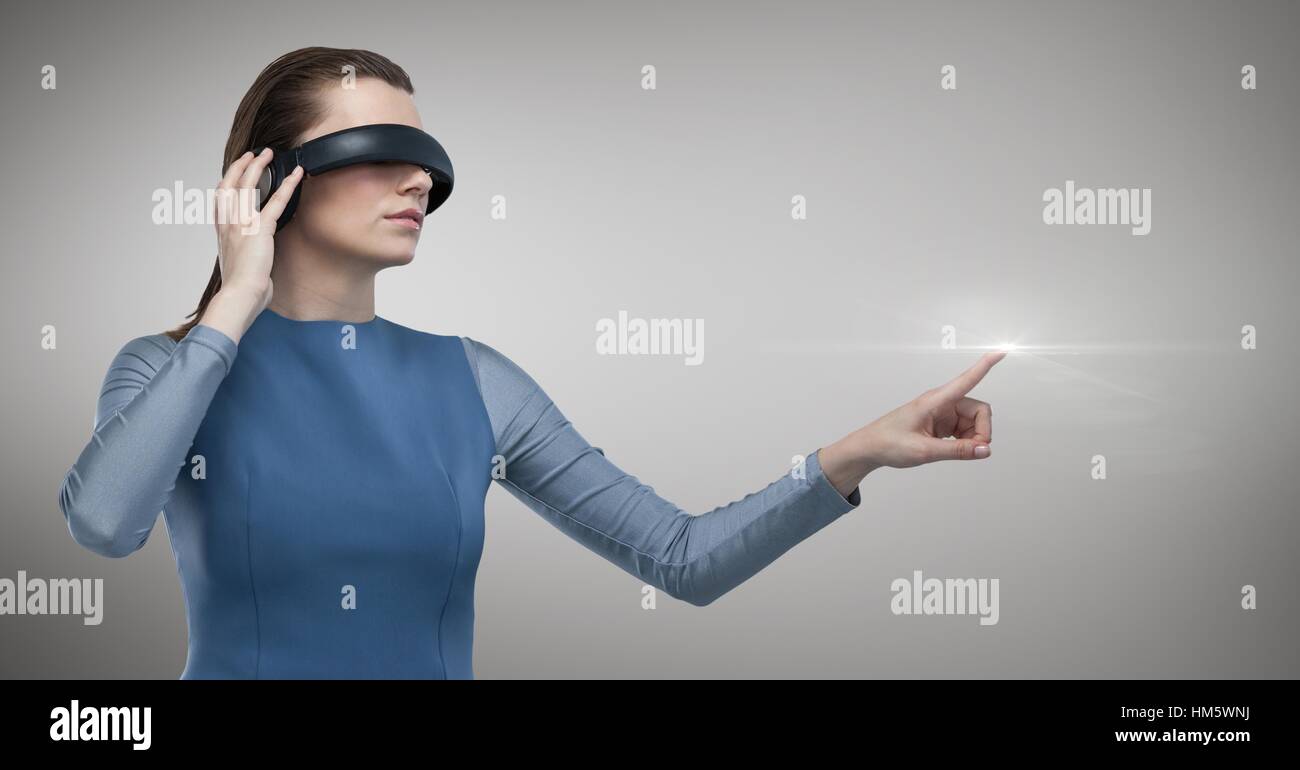 Woman using vr glasses and touching flare Stock Photo - Alamy