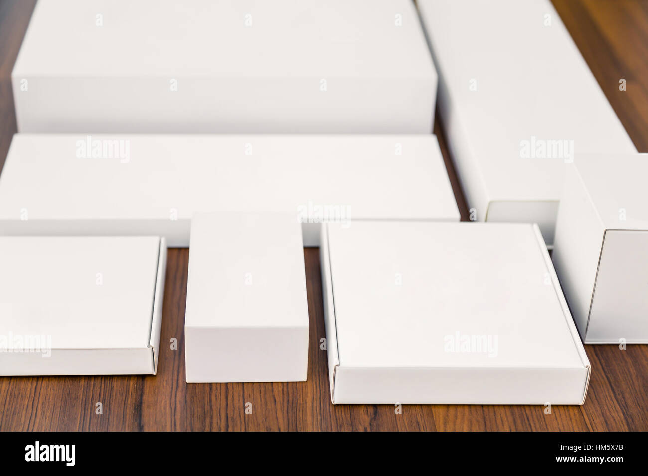 Blank white box mock up on wood background Stock Photo - Alamy