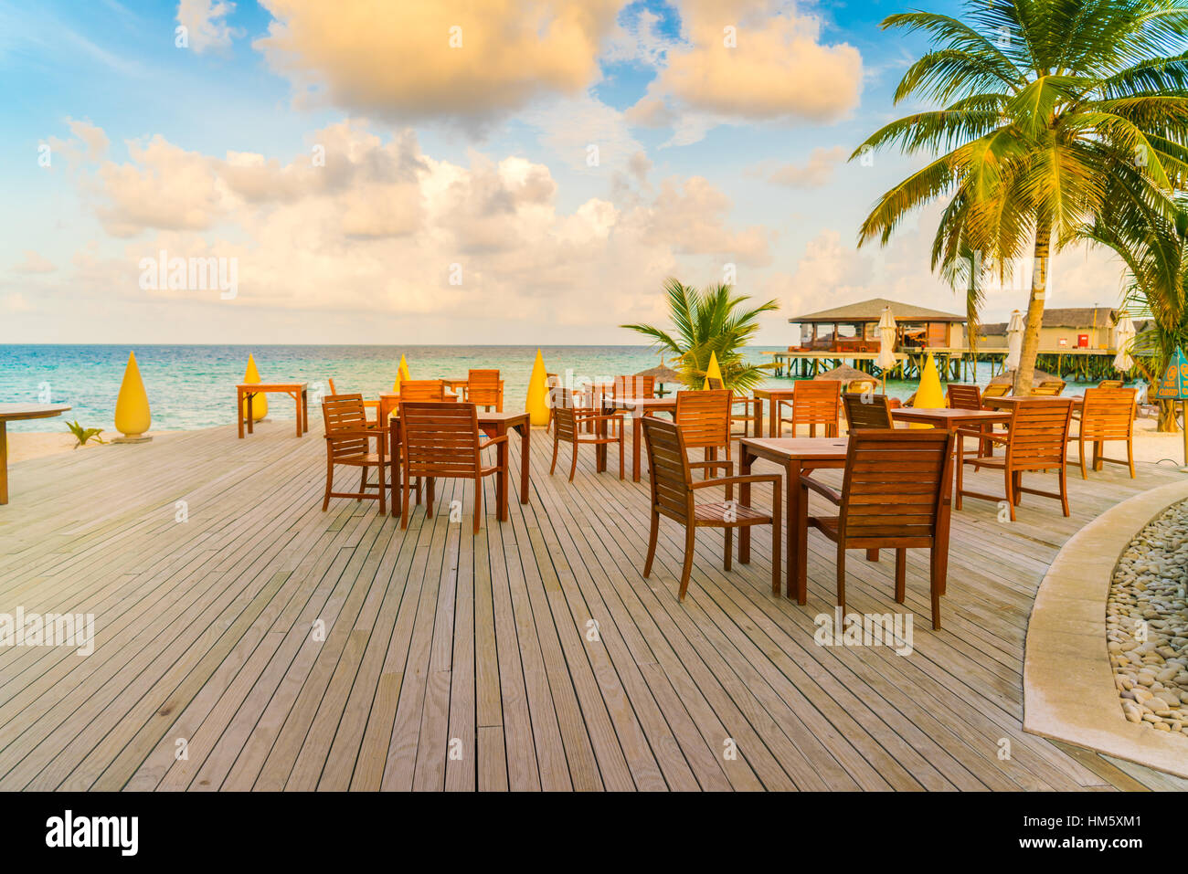 Table and chairs at restaurant in tropical Maldives island Stock Photo ...
