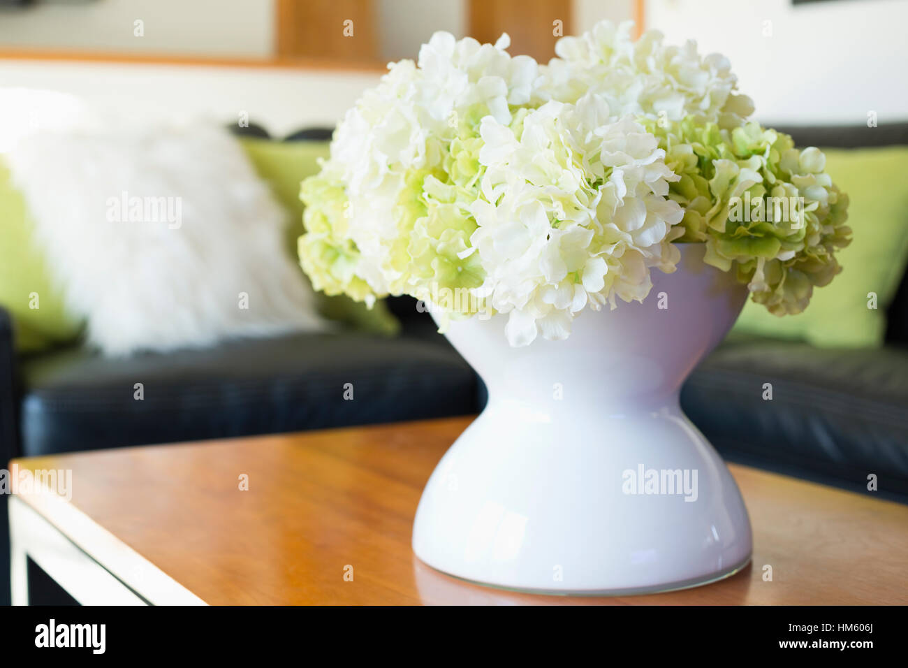 Flower pot on coffee table Stock Photo - Alamy