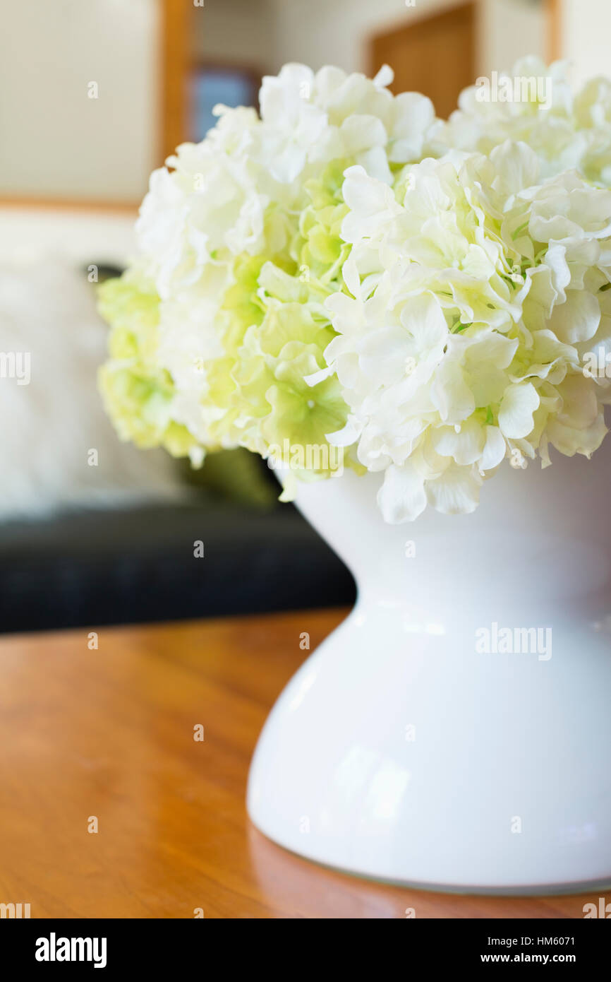 Flower pot on coffee table Stock Photo - Alamy