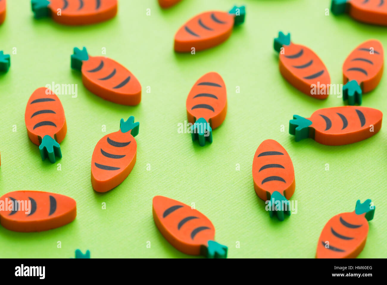 Small carrot decorations on green background Stock Photo - Alamy