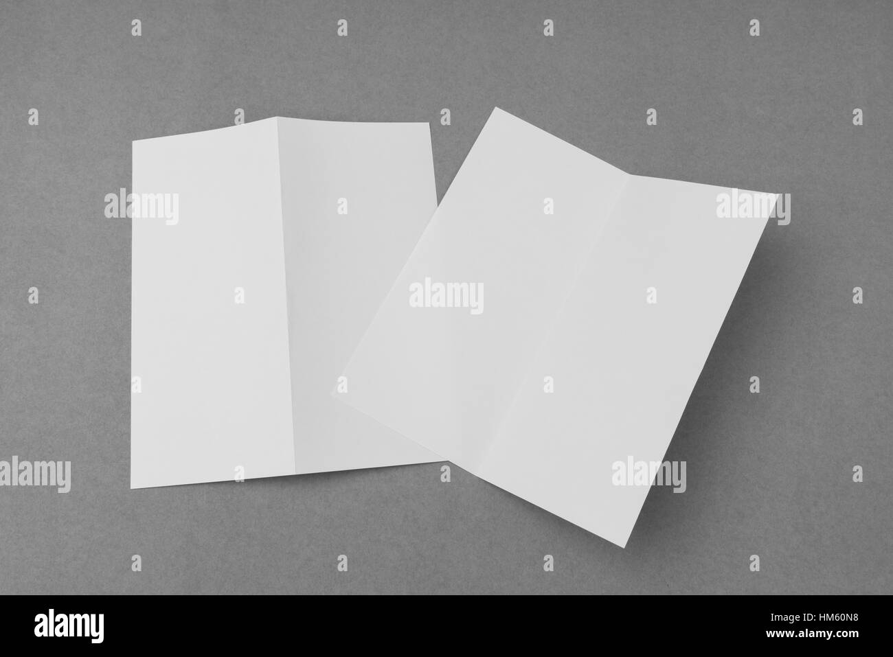 Bifold white template paper on gray background Stock Photo - Alamy