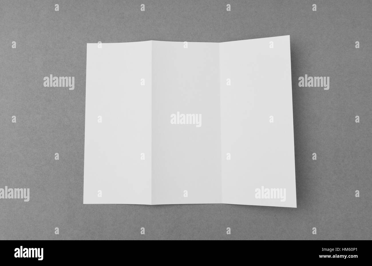 Trifold white template paper on gray background Stock Photo - Alamy