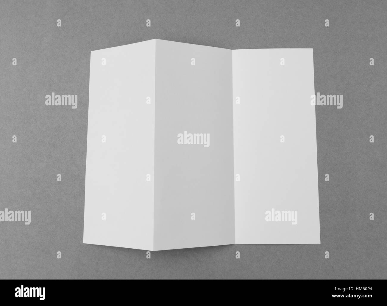 Trifold white template paper on gray background Stock Photo - Alamy