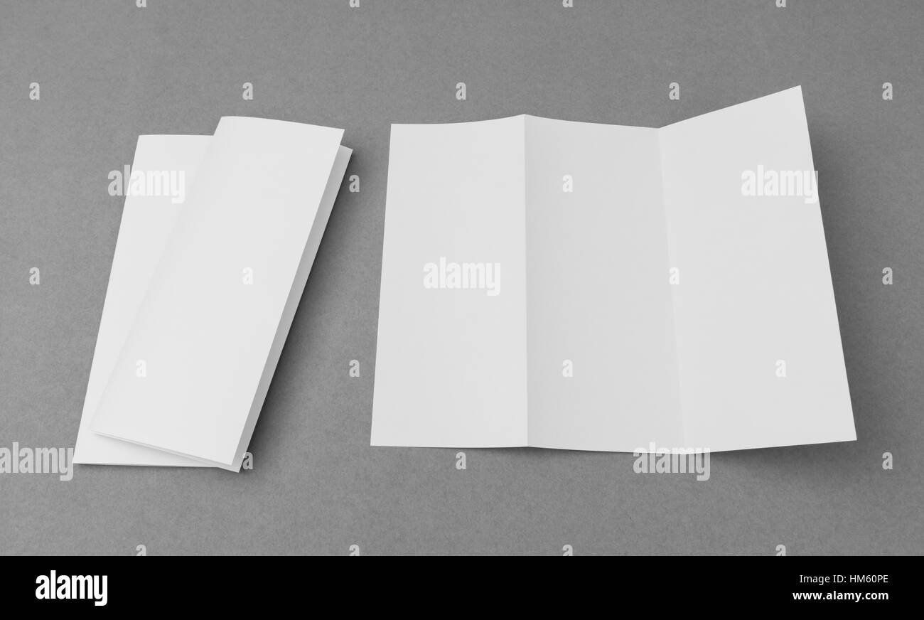 Trifold white template paper on gray background Stock Photo - Alamy