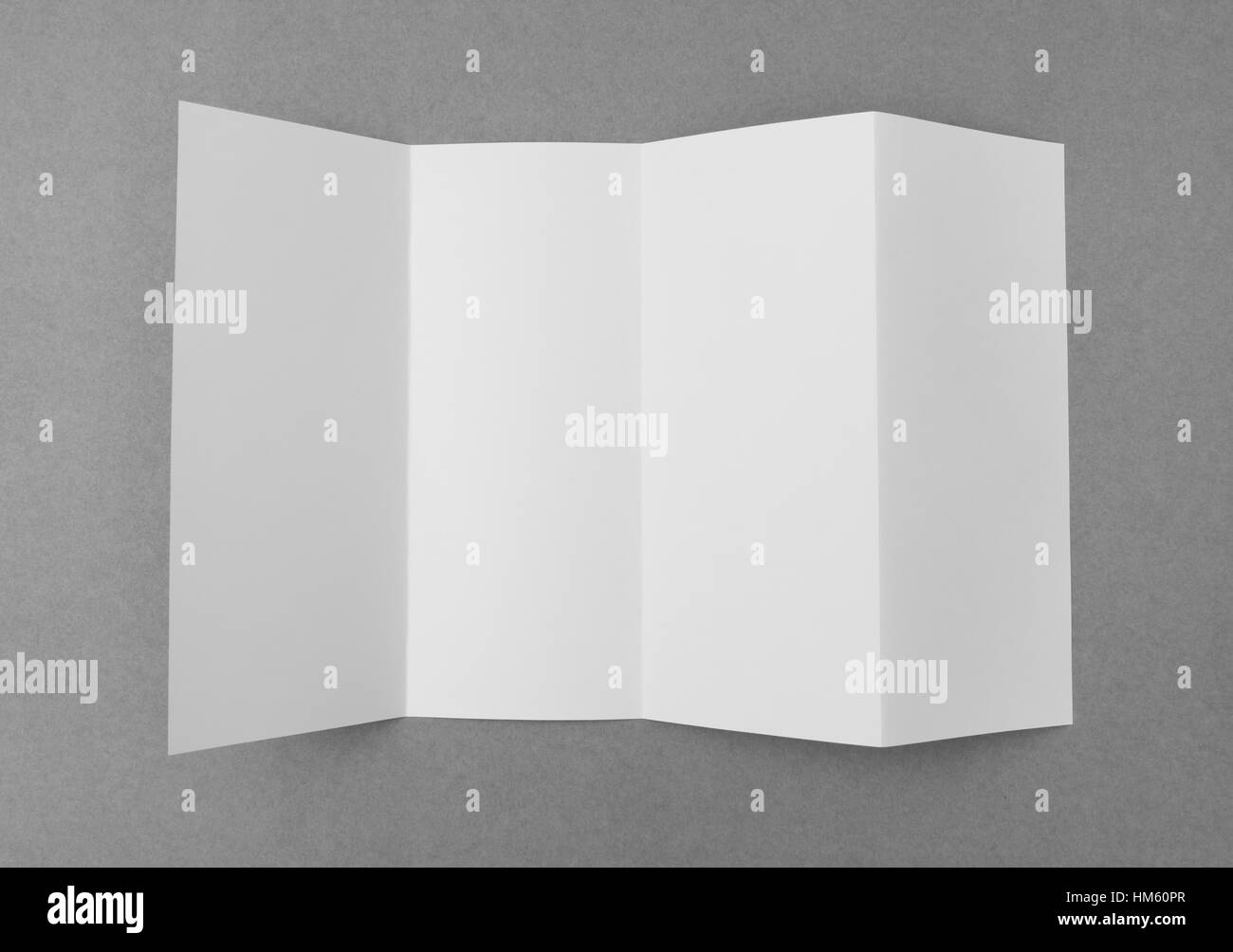 Four - fold white template paper on gray background Stock Photo - Alamy