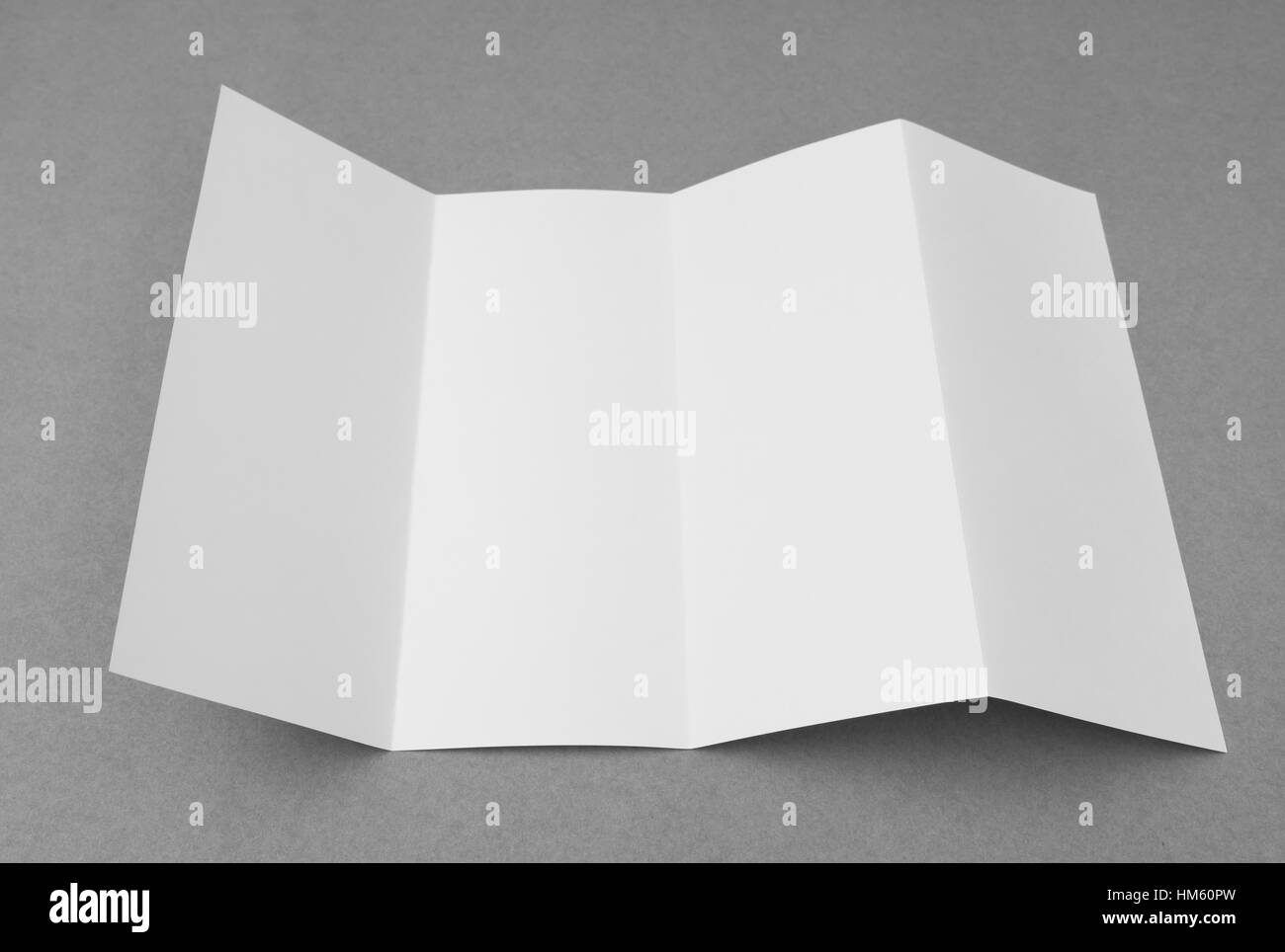 Four - fold white template paper on gray background Stock Photo - Alamy