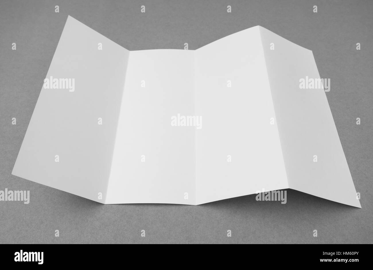 Four - fold white template paper on gray background Stock Photo - Alamy
