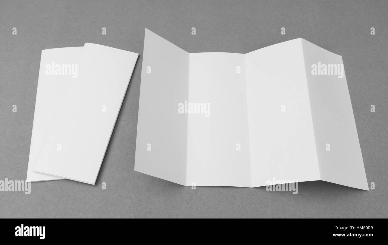 Four - fold white template paper on gray background Stock Photo - Alamy