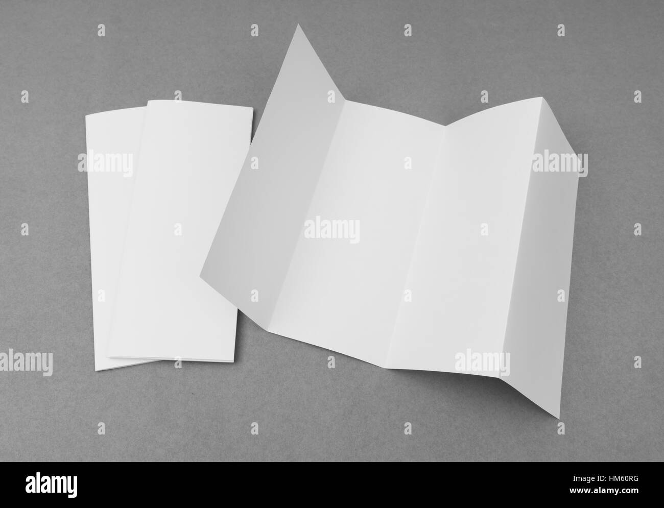Four - fold white template paper on gray background Stock Photo - Alamy