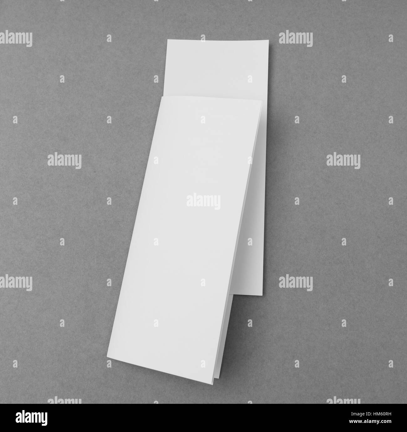 Four - fold white template paper on gray background Stock Photo - Alamy