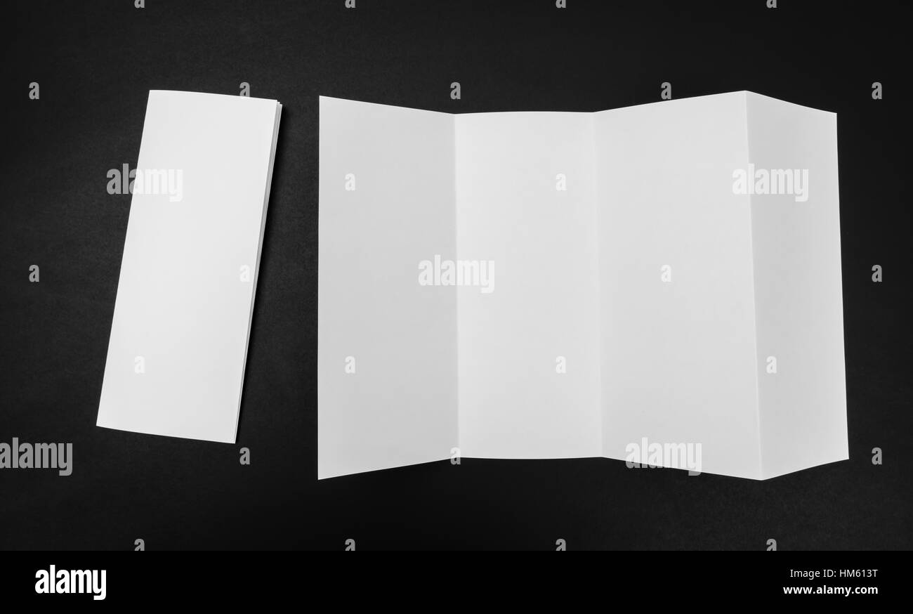 Four - fold white template paper on black background Stock Photo - Alamy