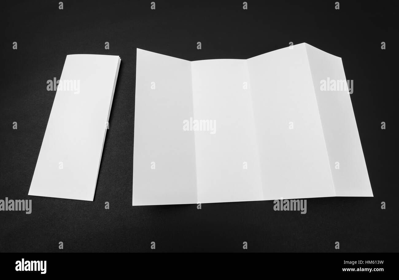 Four - fold white template paper on black background Stock Photo - Alamy
