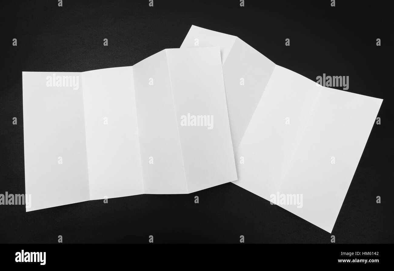 Four - fold white template paper on black background Stock Photo - Alamy