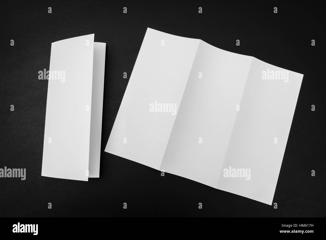 Trifold white template paper on black background Stock Photo - Alamy