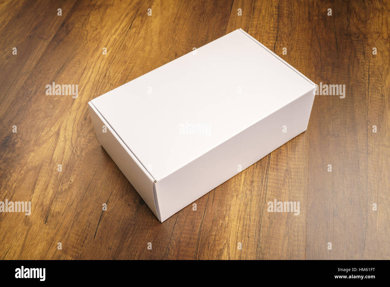 Blank white box mock up on wood background Stock Photo - Alamy