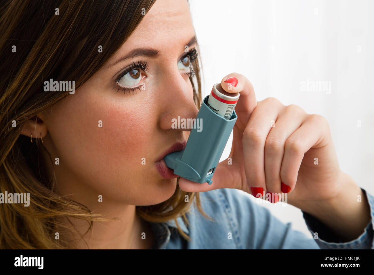 Young woman using asthma inhaler Stock Photo - Alamy