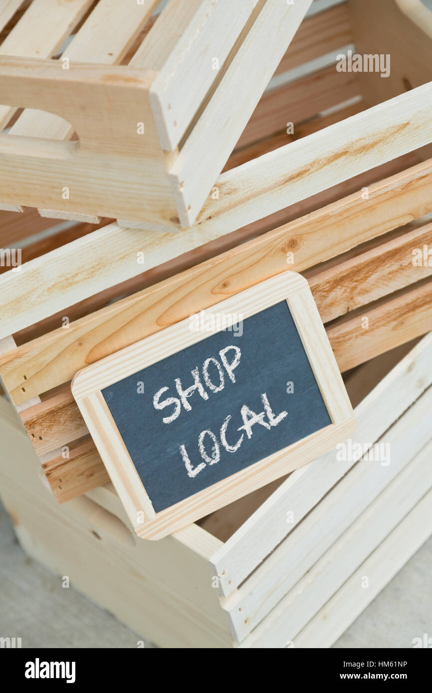 Wooden crates and "shop local" sign Stock Photo - Alamy