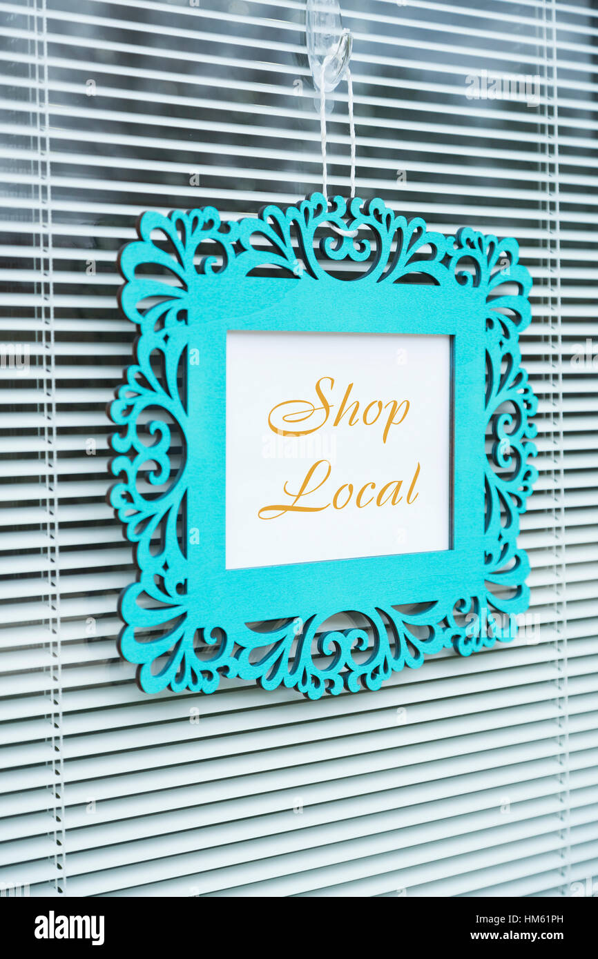 "Shop local" sign on doors Stock Photo - Alamy