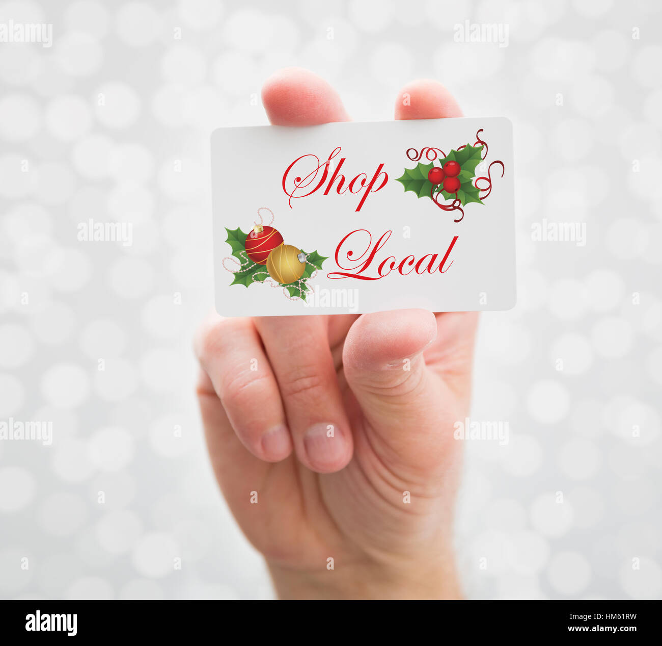Man holding card with "shop local" words Stock Photo - Alamy