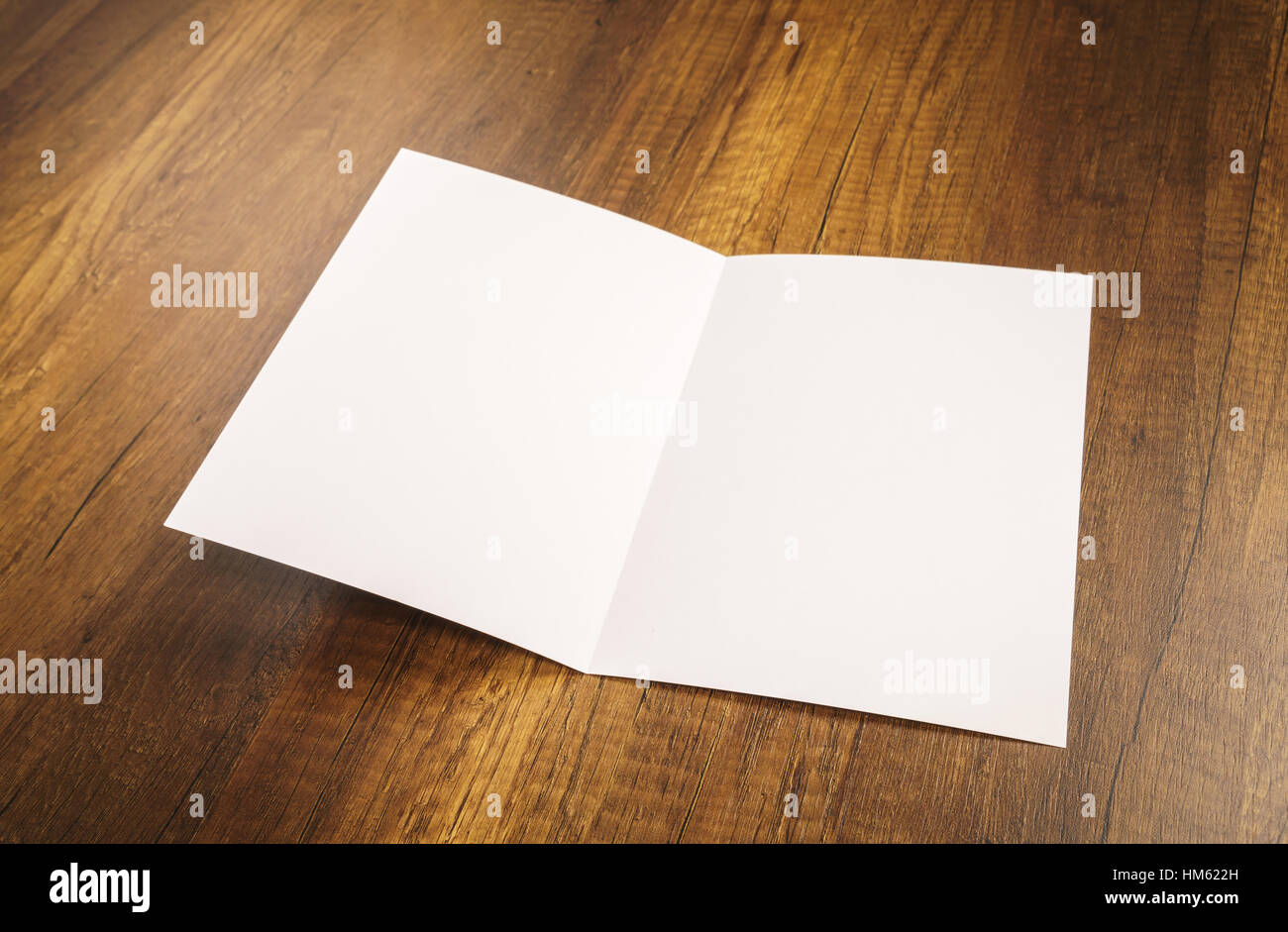 Bifold white template paper on wood texture Stock Photo - Alamy