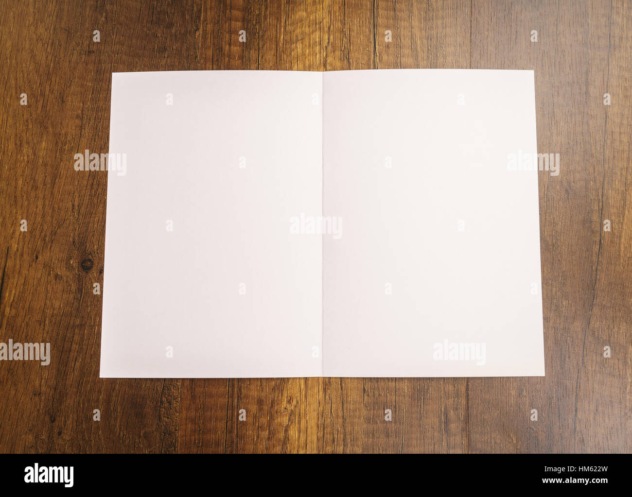 Bifold white template paper on wood texture Stock Photo - Alamy
