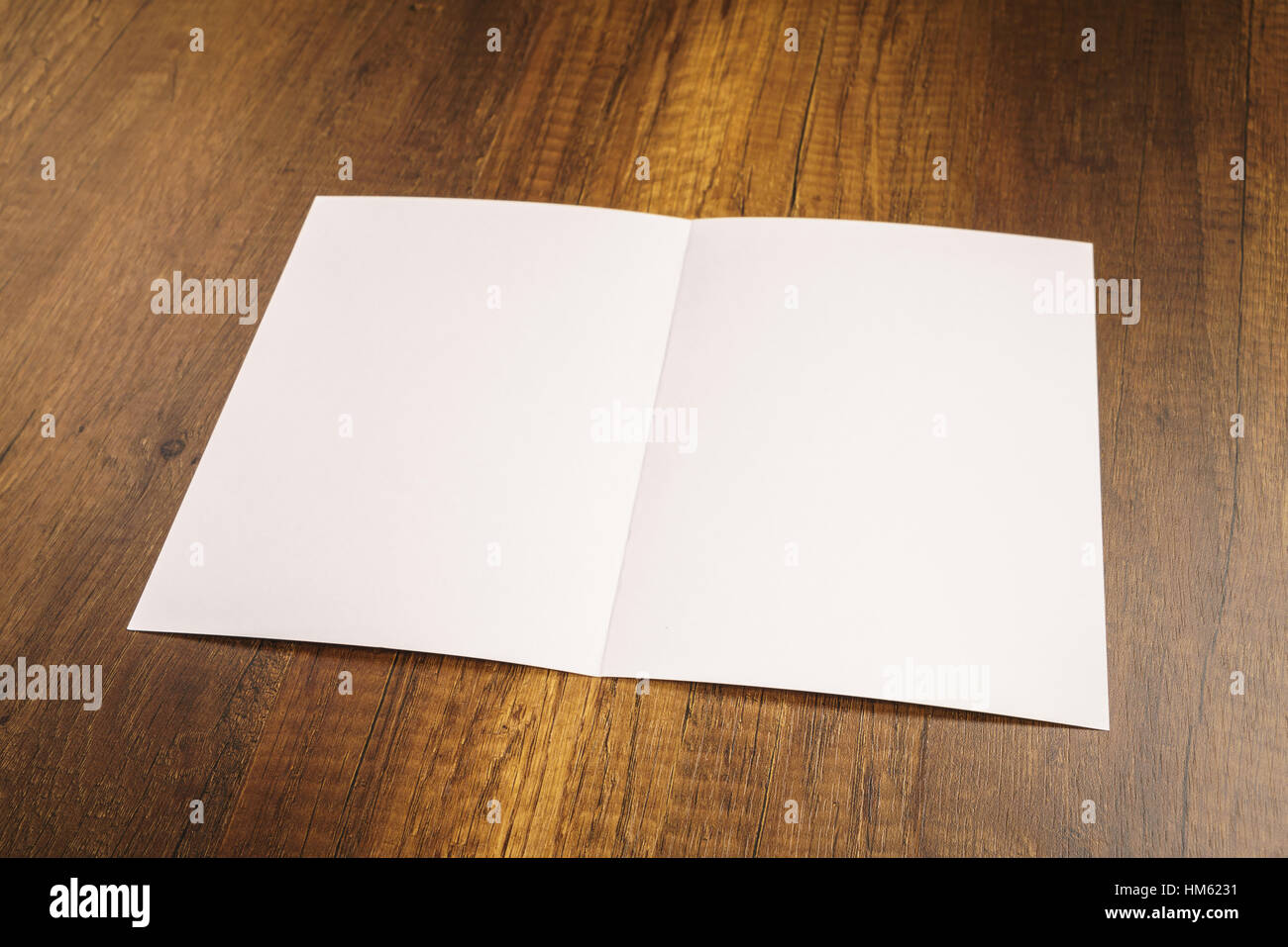 Bifold white template paper on wood texture Stock Photo - Alamy