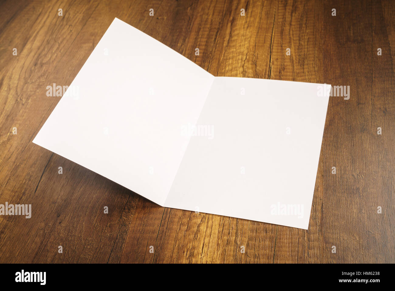 Bifold white template paper on wood texture Stock Photo - Alamy