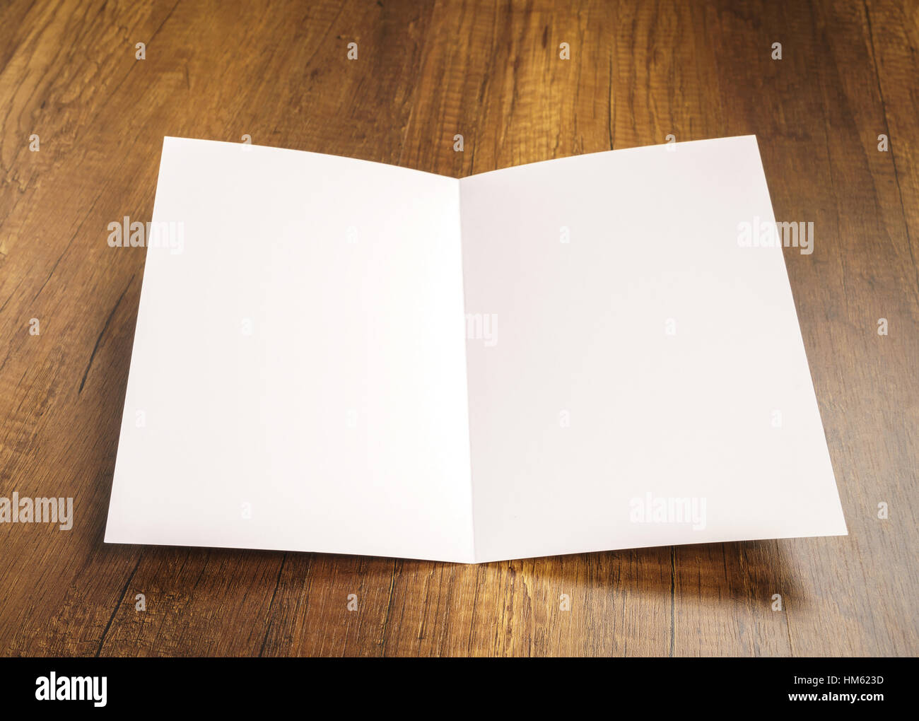 Bifold white template paper on wood texture Stock Photo - Alamy