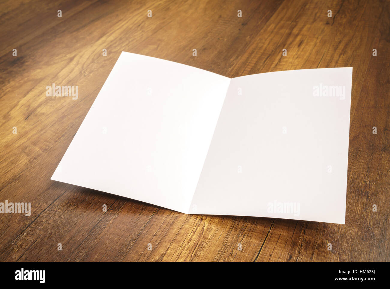 Bifold white template paper on wood texture Stock Photo - Alamy