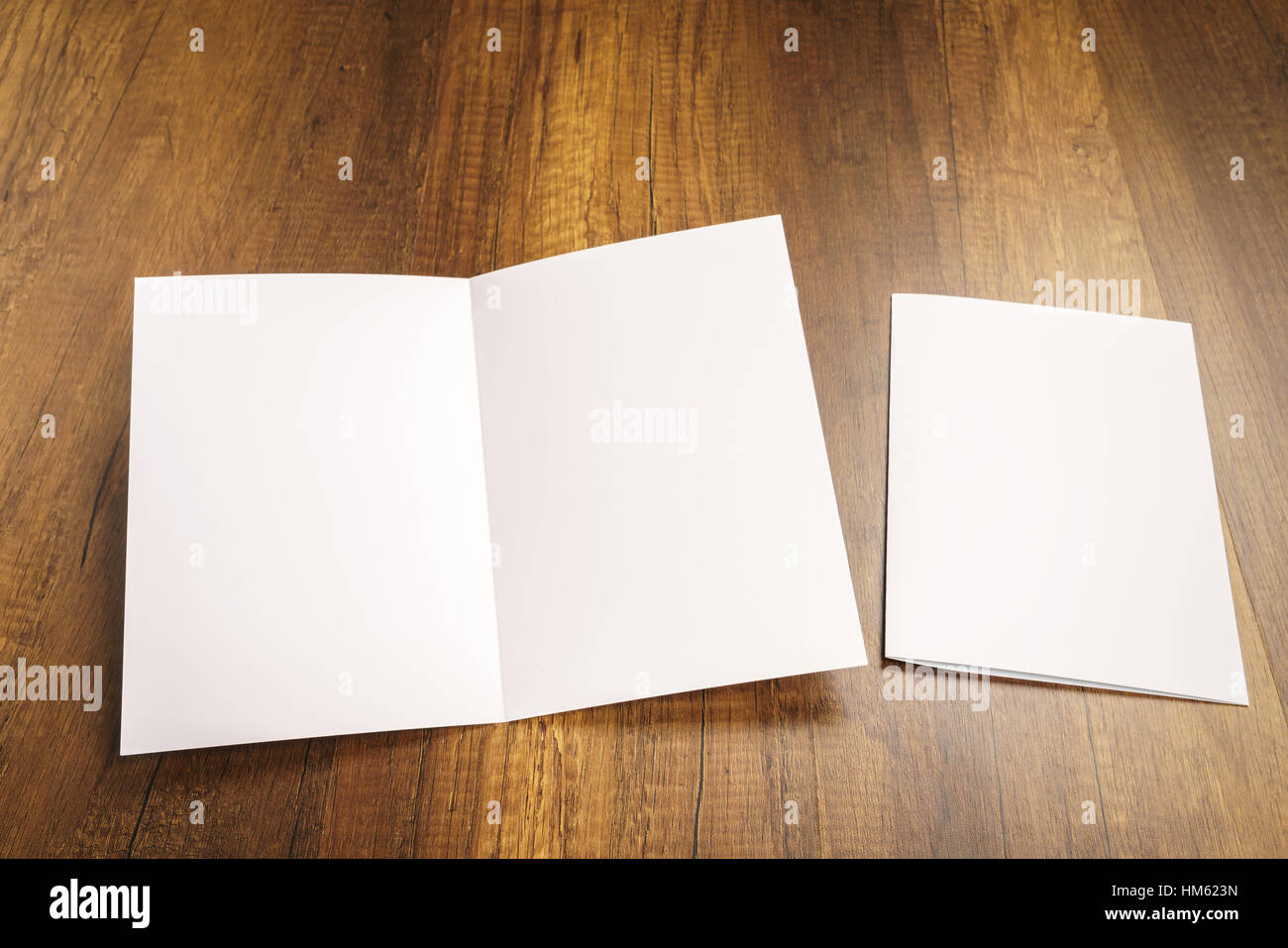 Bifold white template paper on wood texture Stock Photo - Alamy
