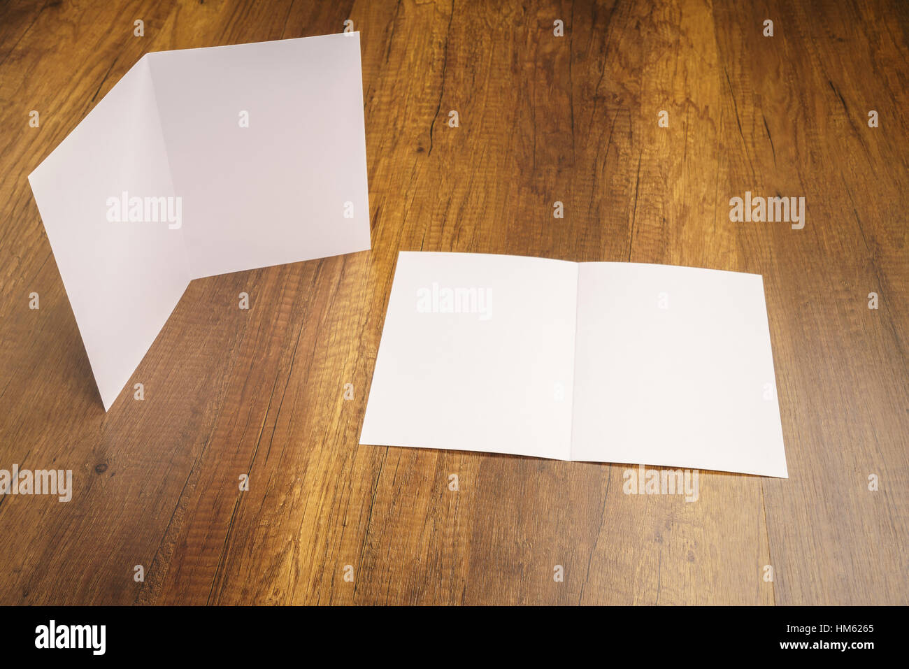 Bifold white template paper on wood texture Stock Photo - Alamy