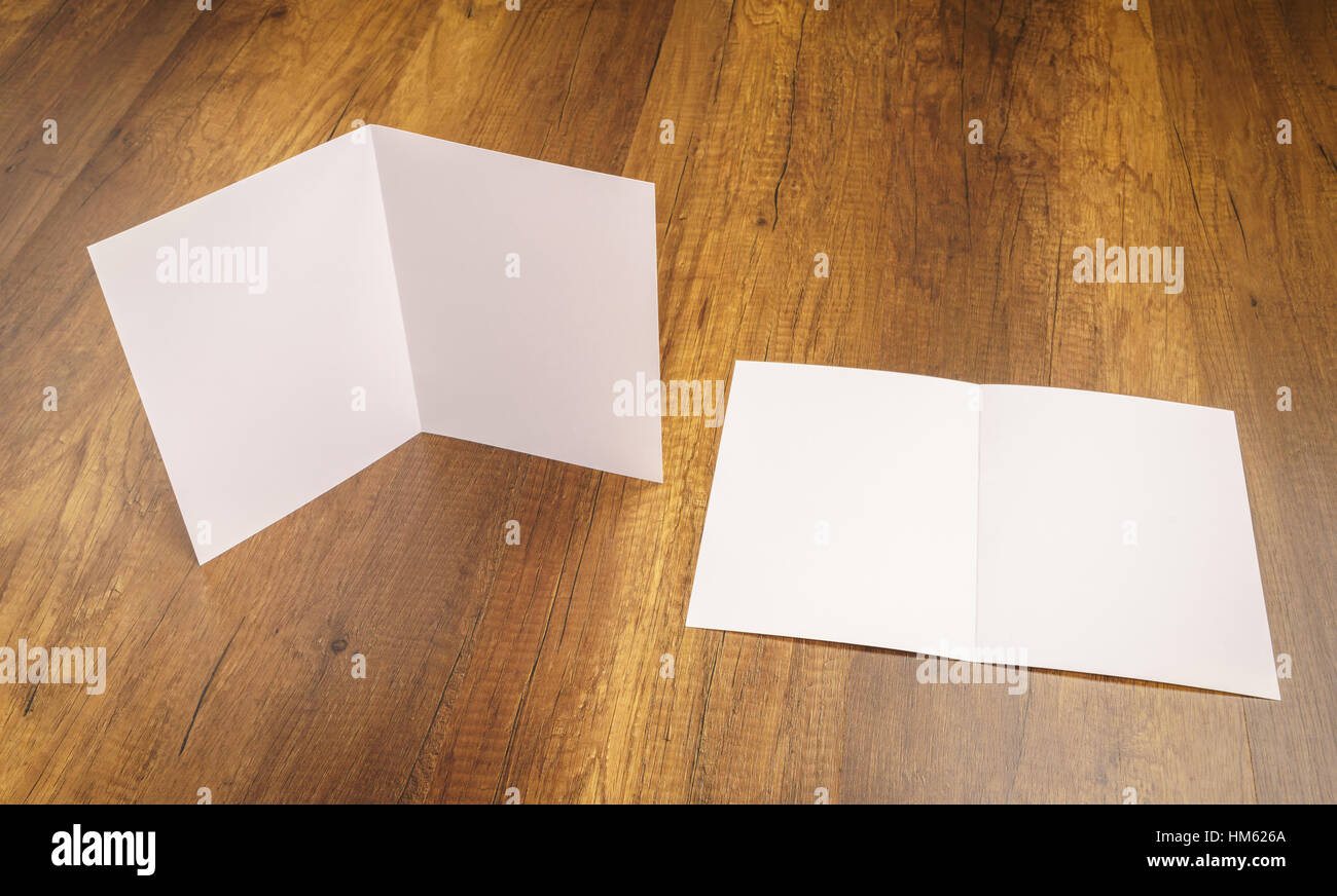 Bifold white template paper on wood texture Stock Photo - Alamy