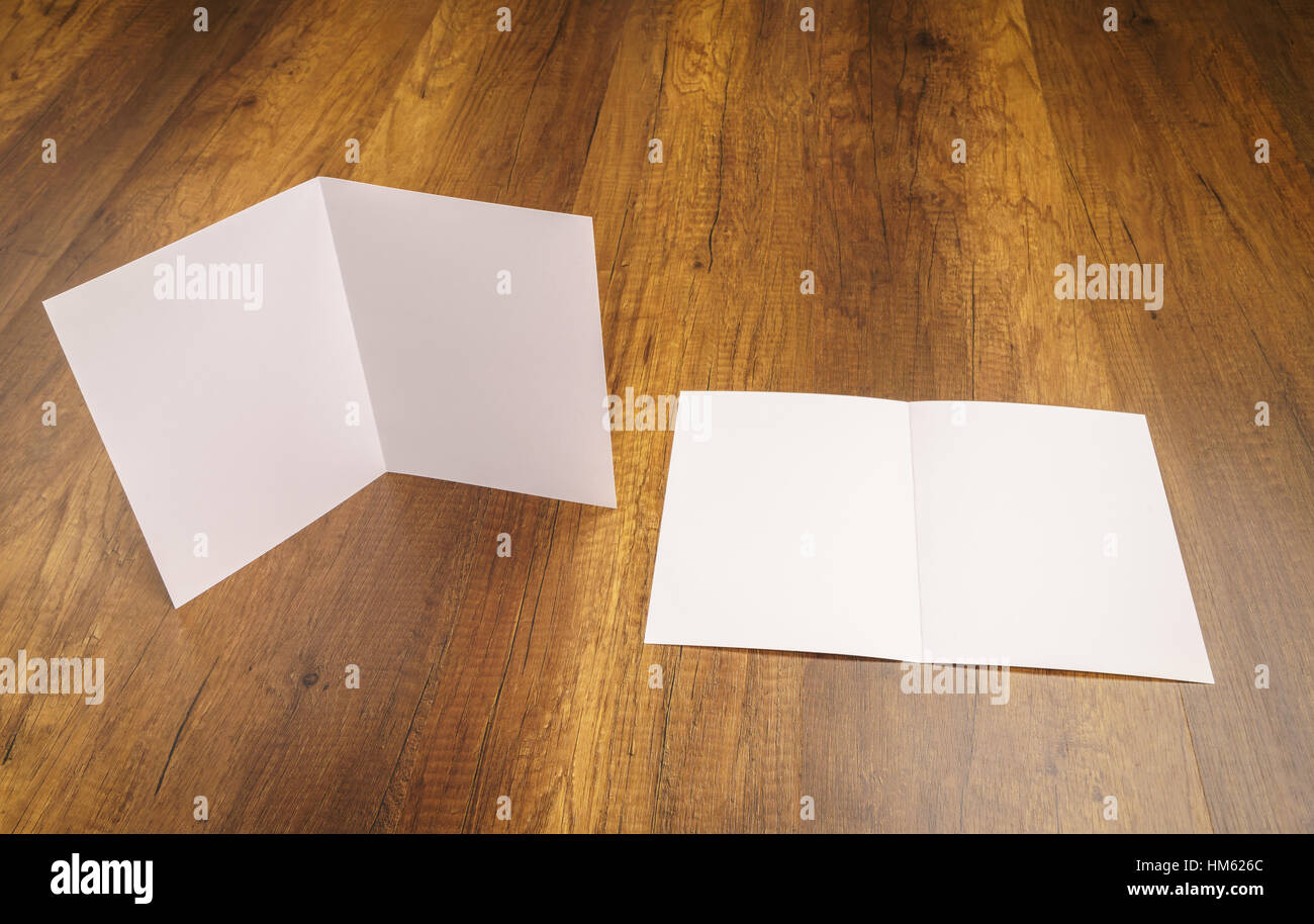 Bifold white template paper on wood texture Stock Photo - Alamy