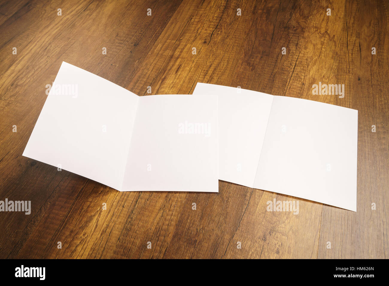 Bifold white template paper on wood texture Stock Photo - Alamy