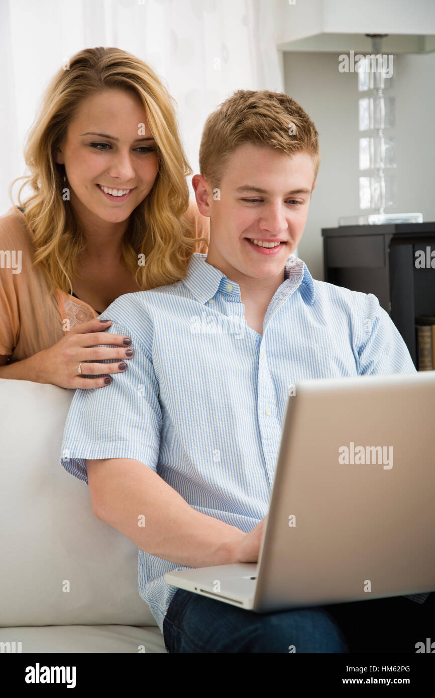 Young couple using laptop Stock Photo - Alamy