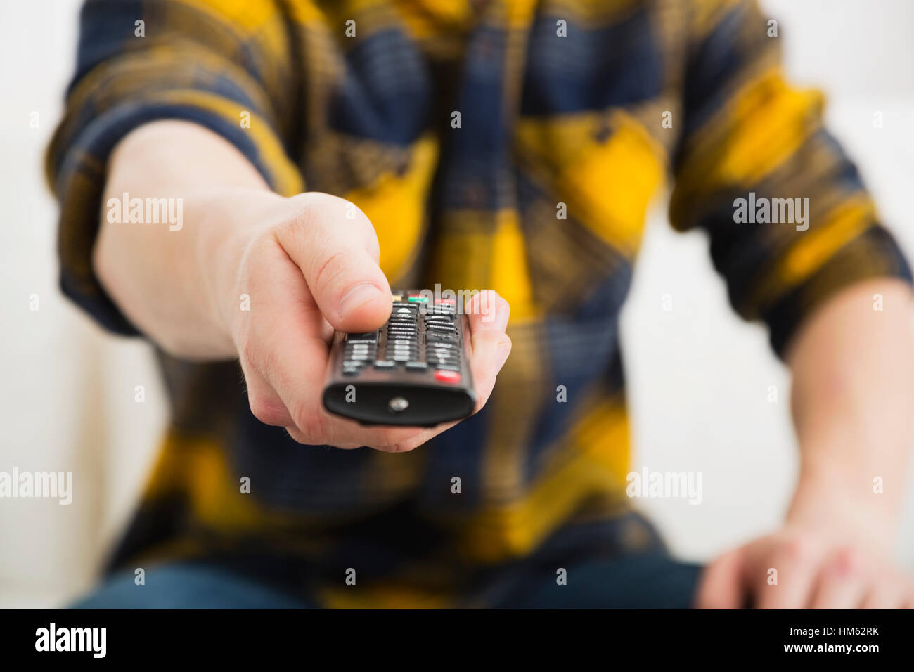 Young man using remote Stock Photo - Alamy
