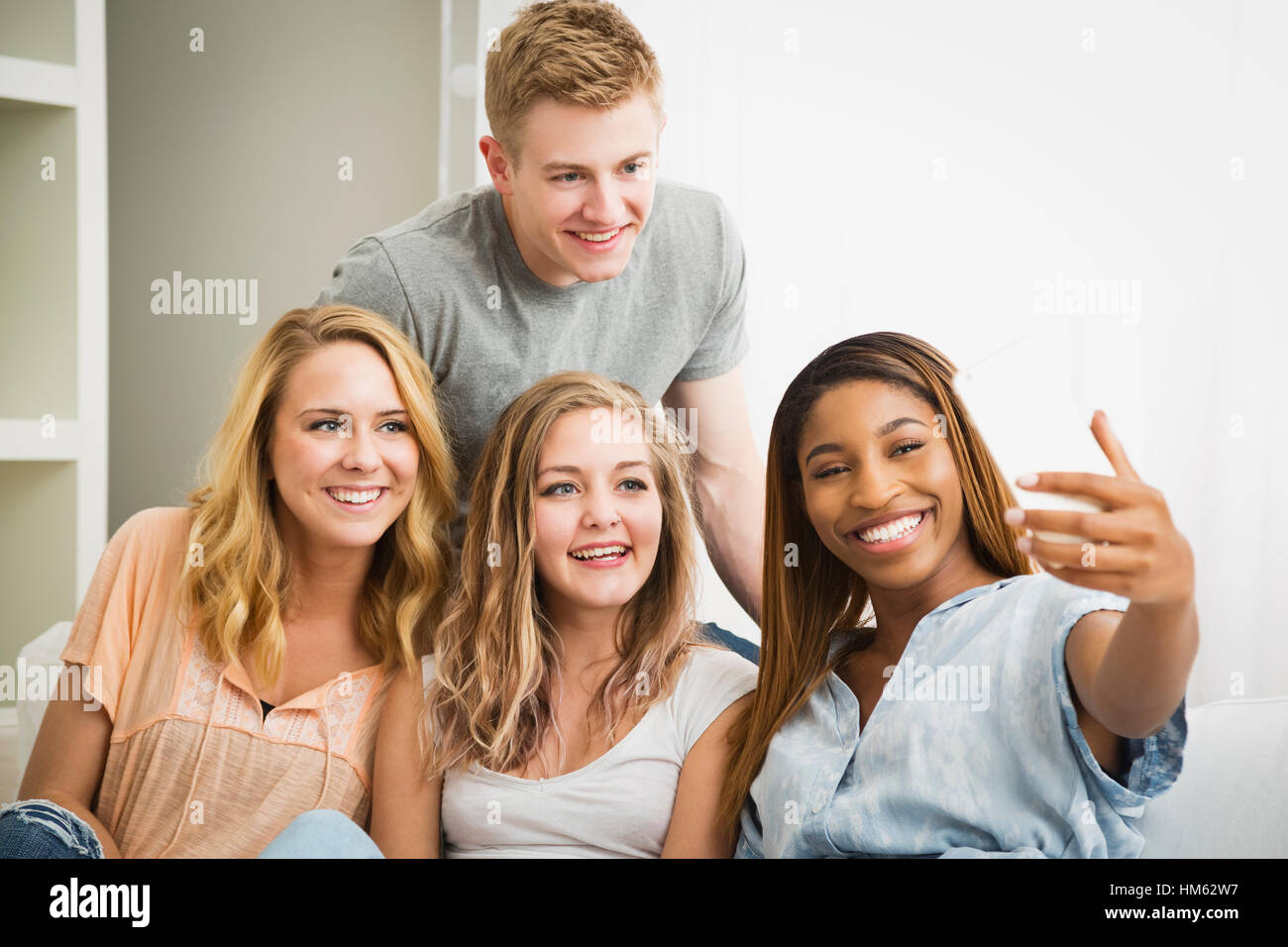 Young people photographing self in bright room Stock Photo - Alamy