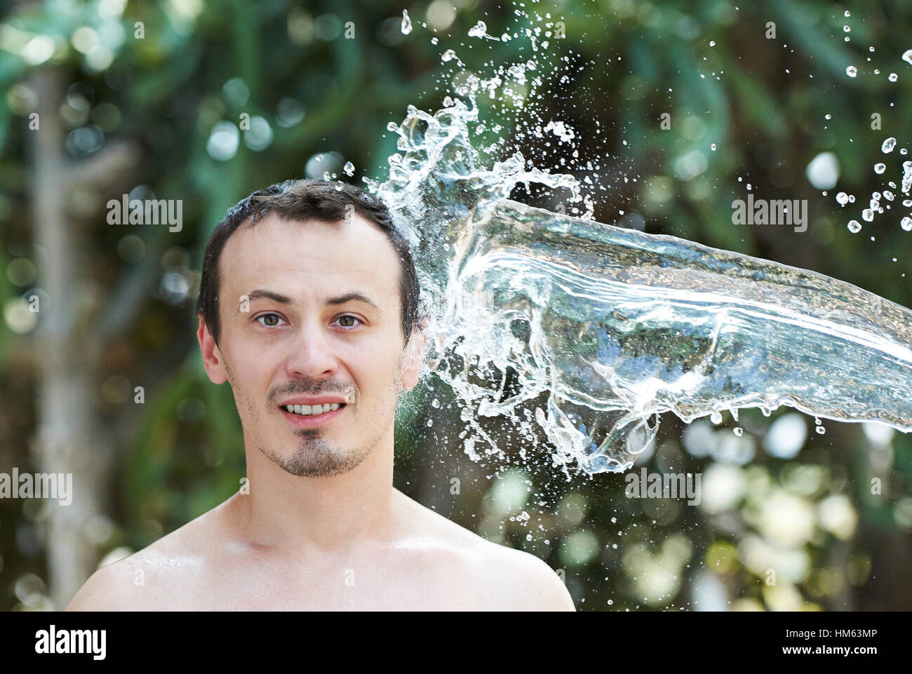 water splash punch in man head on green blur background Stock Photo - Alamy
