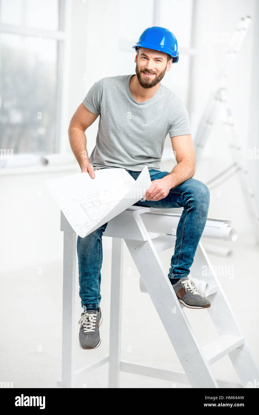 Portrait of a handsome builder, foreman or repairman in the helmet ...