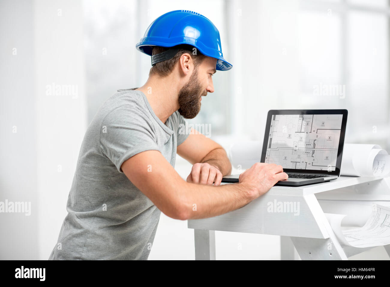 Architect working with laptop at the structure interior Stock Photo - Alamy